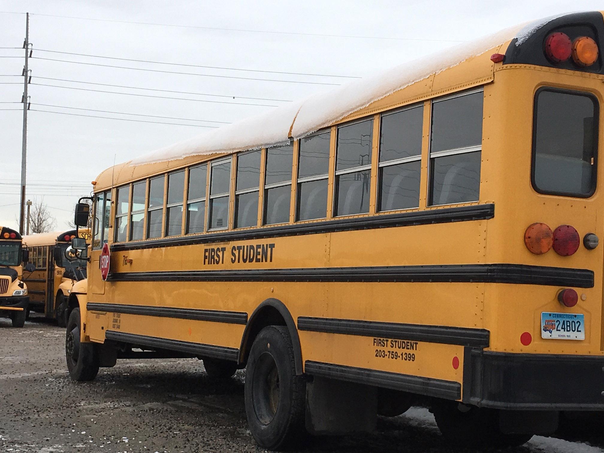 School buses seen on the road with visible ice on top in New Haven ...