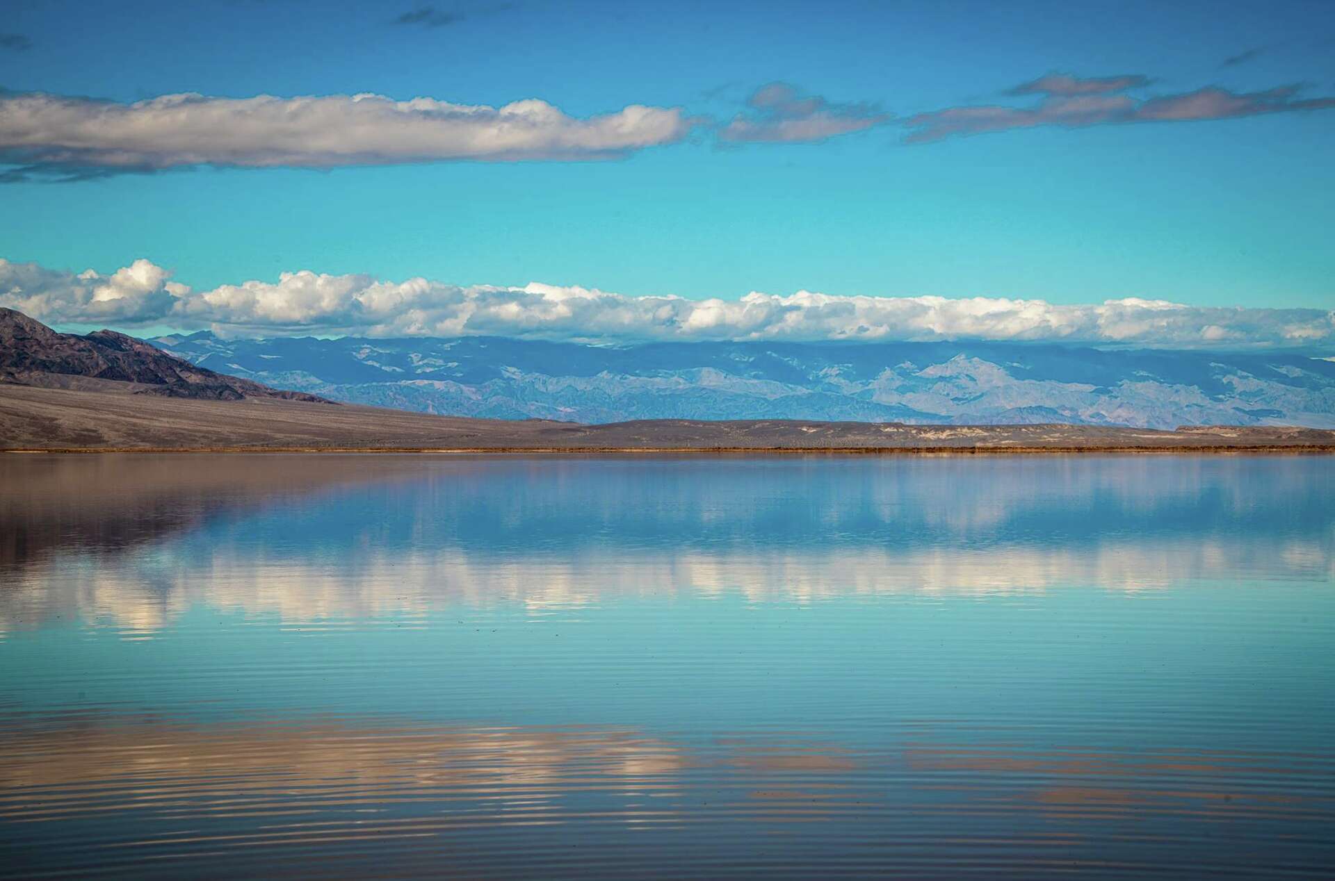 Rare 10-mile-long lake forms in Death Valley after heavy rains and flooding