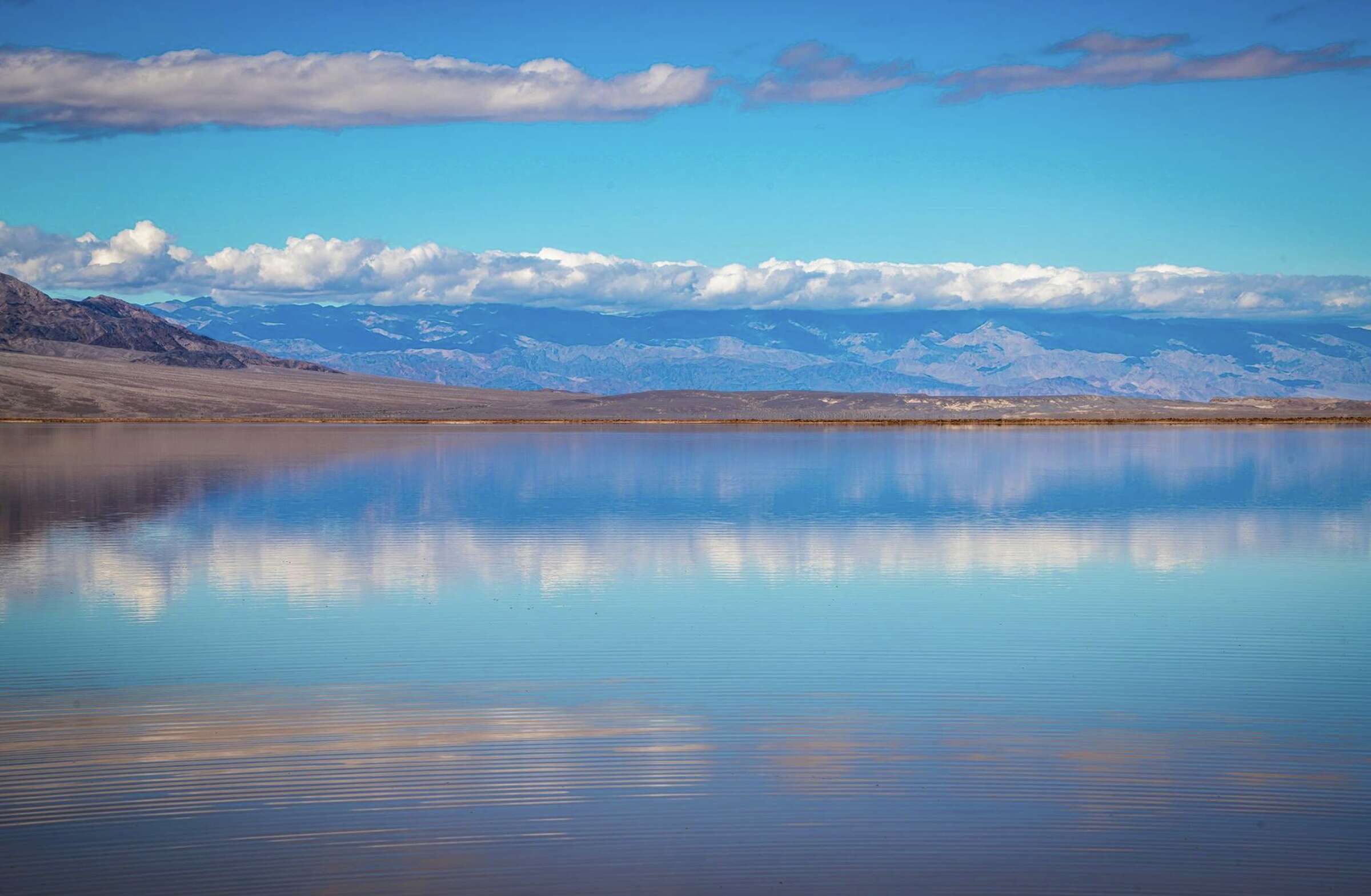 Rare 10-mile-long lake forms in Death Valley after heavy rains and flooding