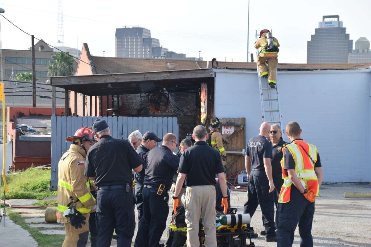 Firefighter falls through roof while extinguishing blaze at downtown bar