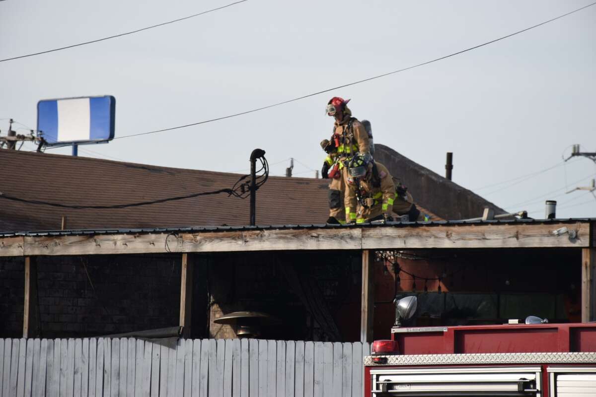 Firefighter falls through roof while extinguishing blaze at downtown bar