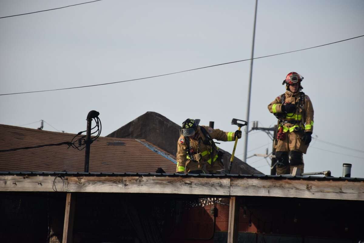 Firefighter falls through roof while extinguishing blaze at downtown bar