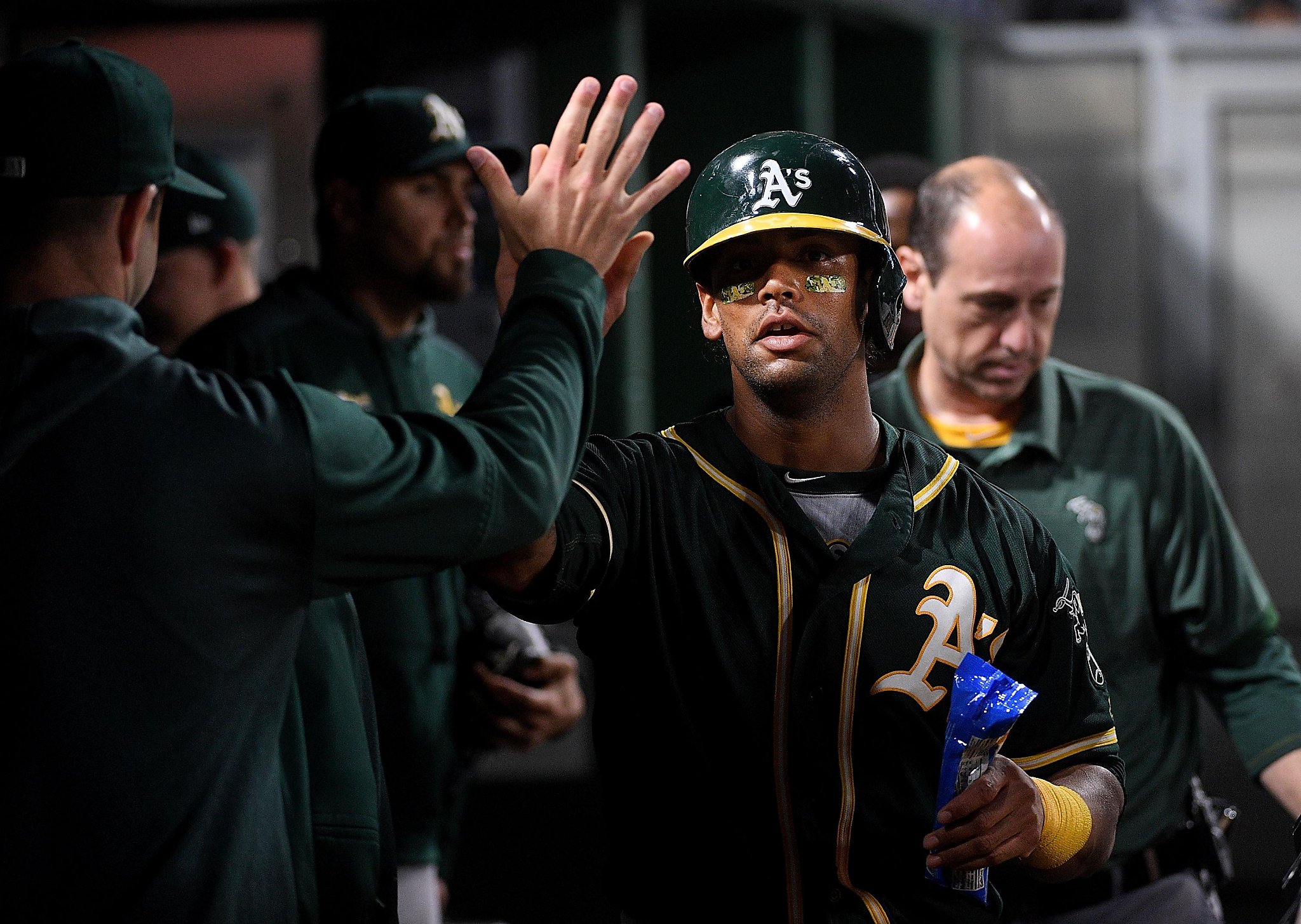 A’s Khris Davis leaves with hip contusion after running into side wall