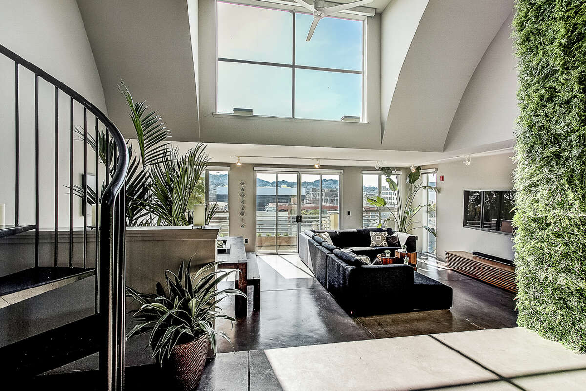 A faux living wall is the centerpiece of this $1M SF penthouse loft