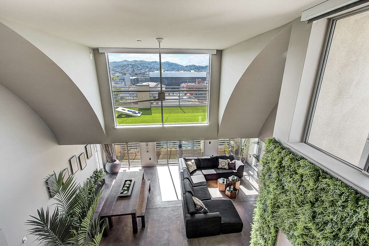 A faux living wall is the centerpiece of this $1M SF penthouse loft