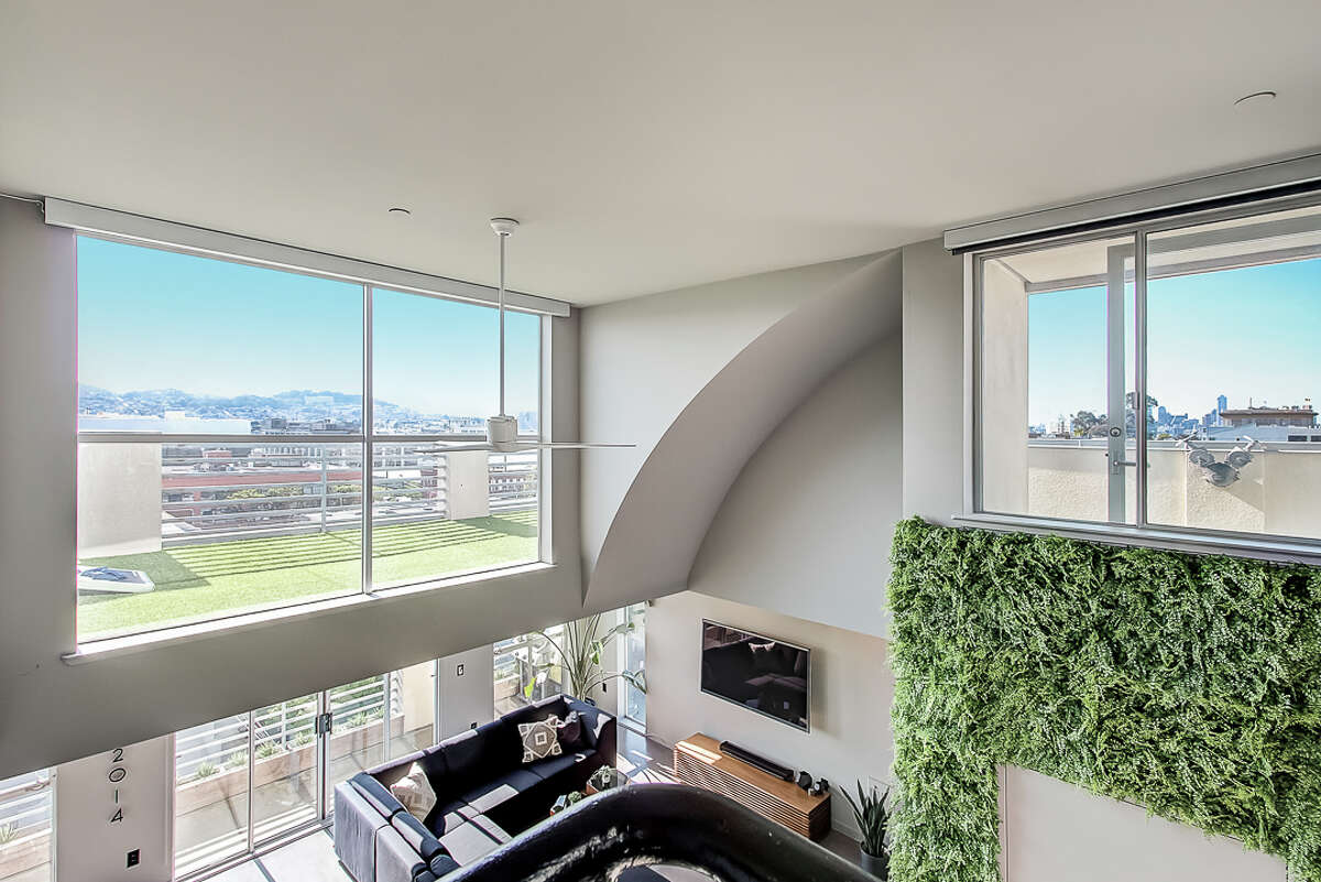A faux living wall is the centerpiece of this $1M SF penthouse loft