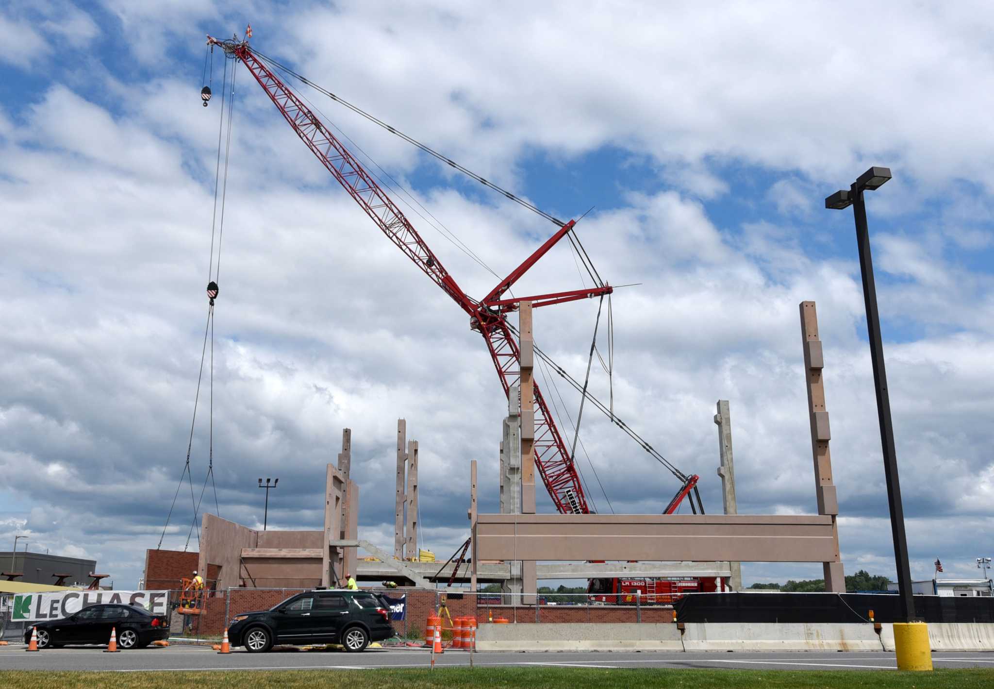 Workers complete airport parking garage structure