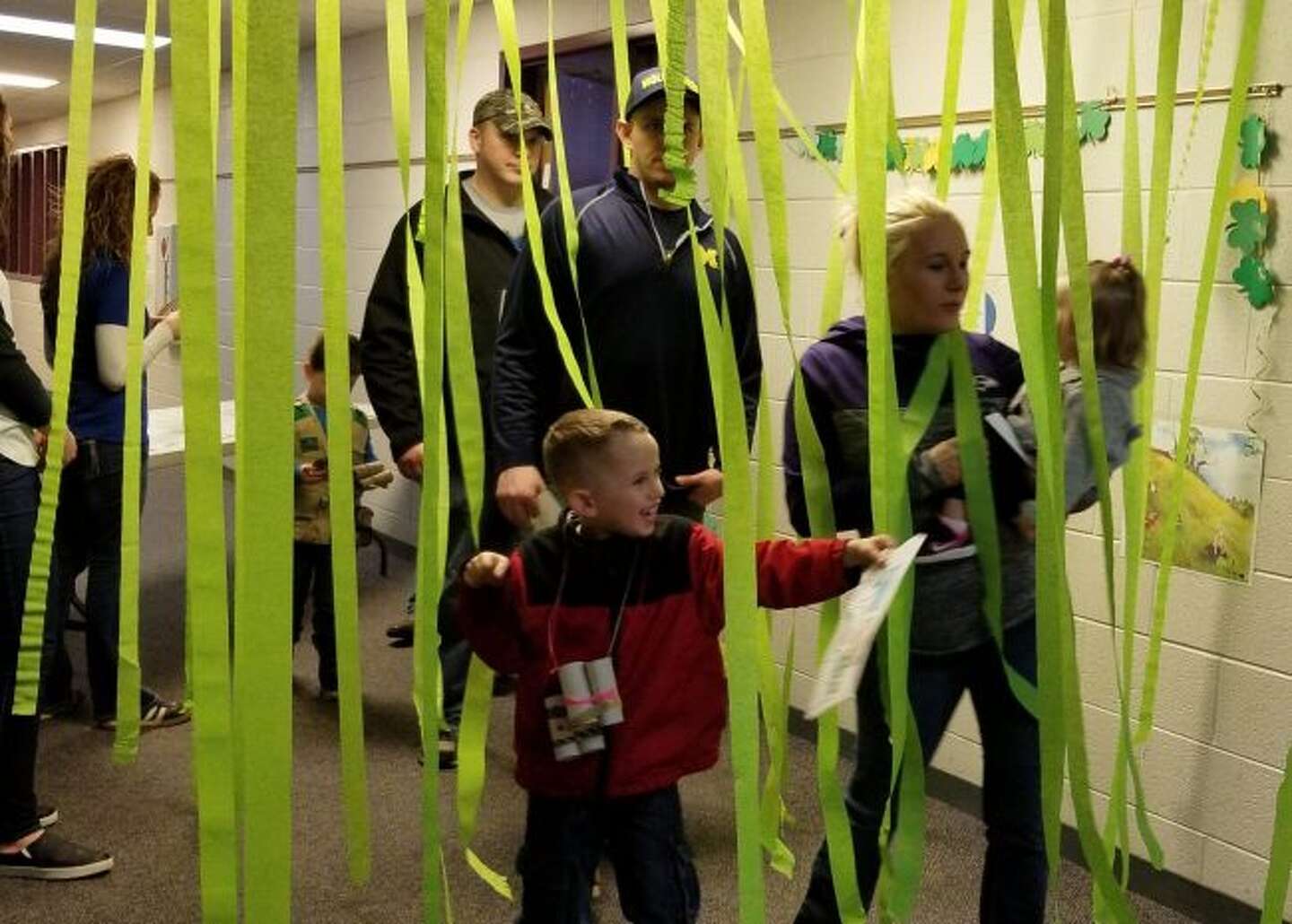 Families play together on interactive story walk