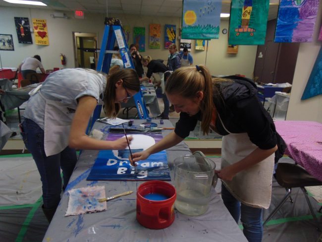 Selected artists paint banners to decorate city