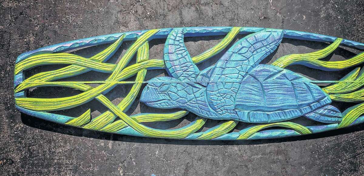 Florida artist carving new life into old surf boards