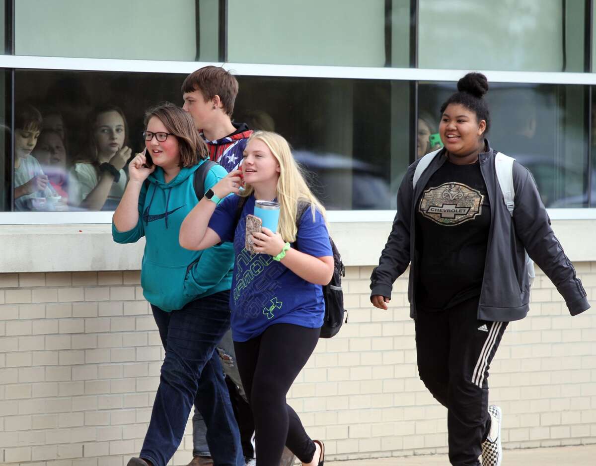 Students walk out in support of former teacher, coach