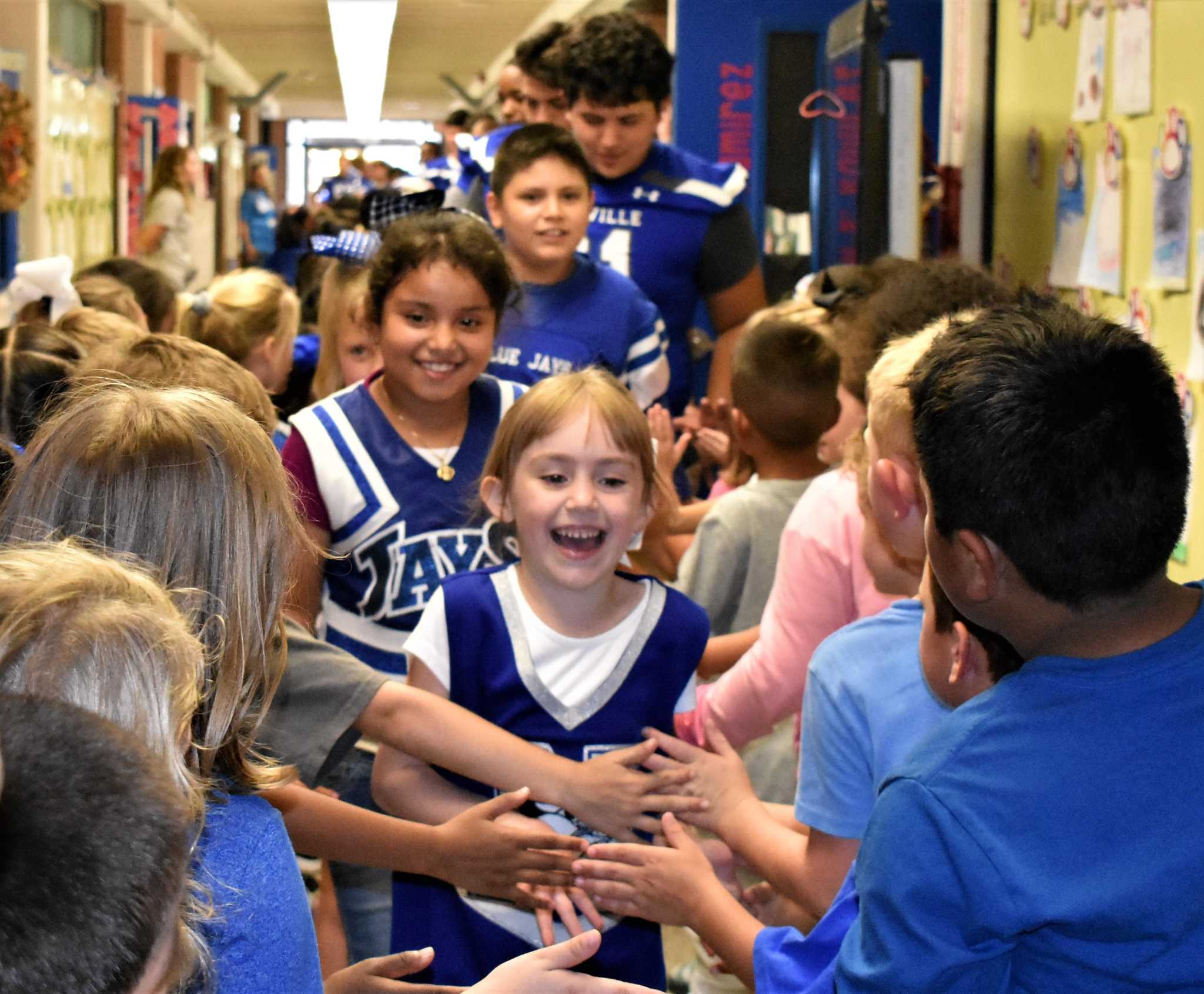 Needville football players make way through elementary school