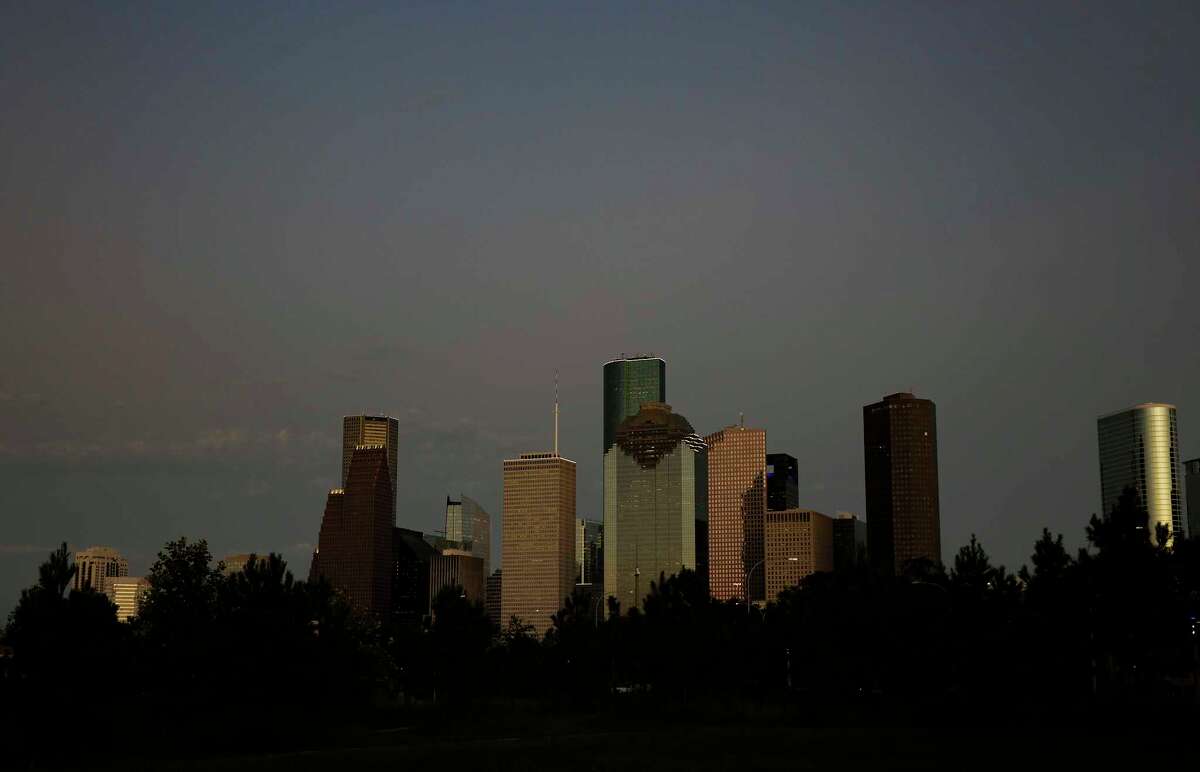 Volcanic ash dusts Houston skyline with purple haze