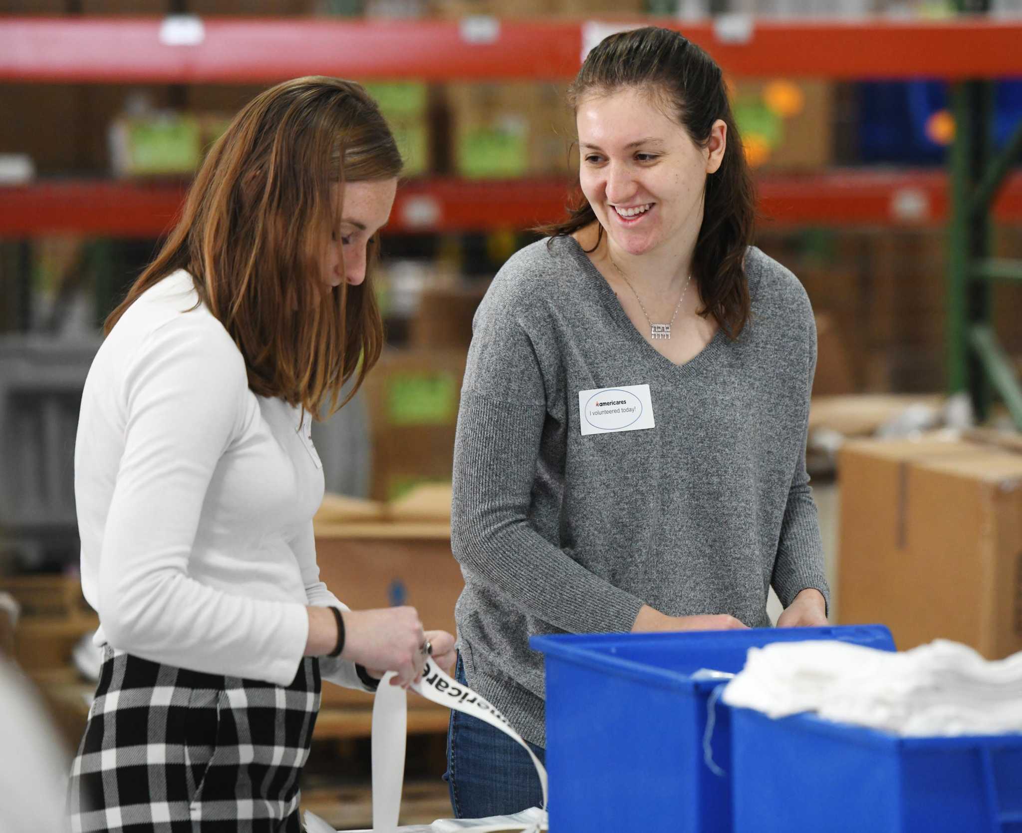 Volunteers assemble 3,000 care packages for Americares