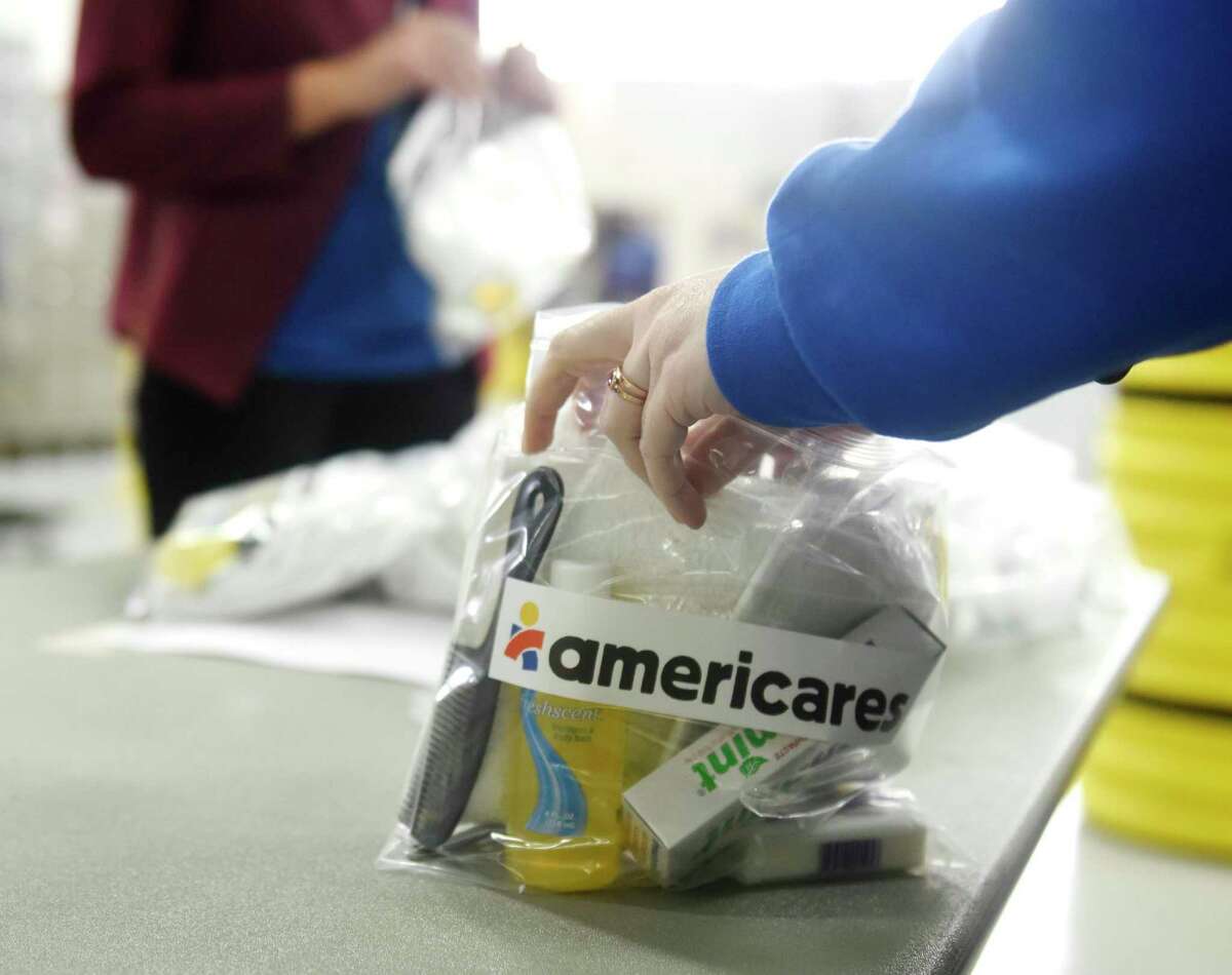 Volunteers assemble 3,000 care packages for Americares