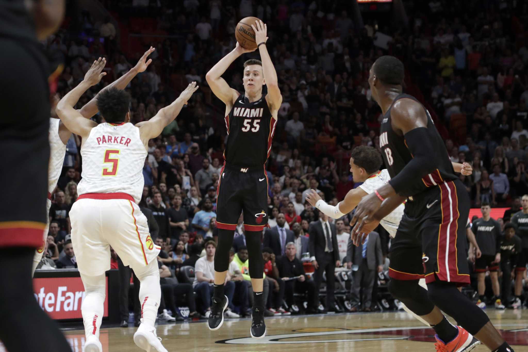 Heat use late run to top Hawks in OT