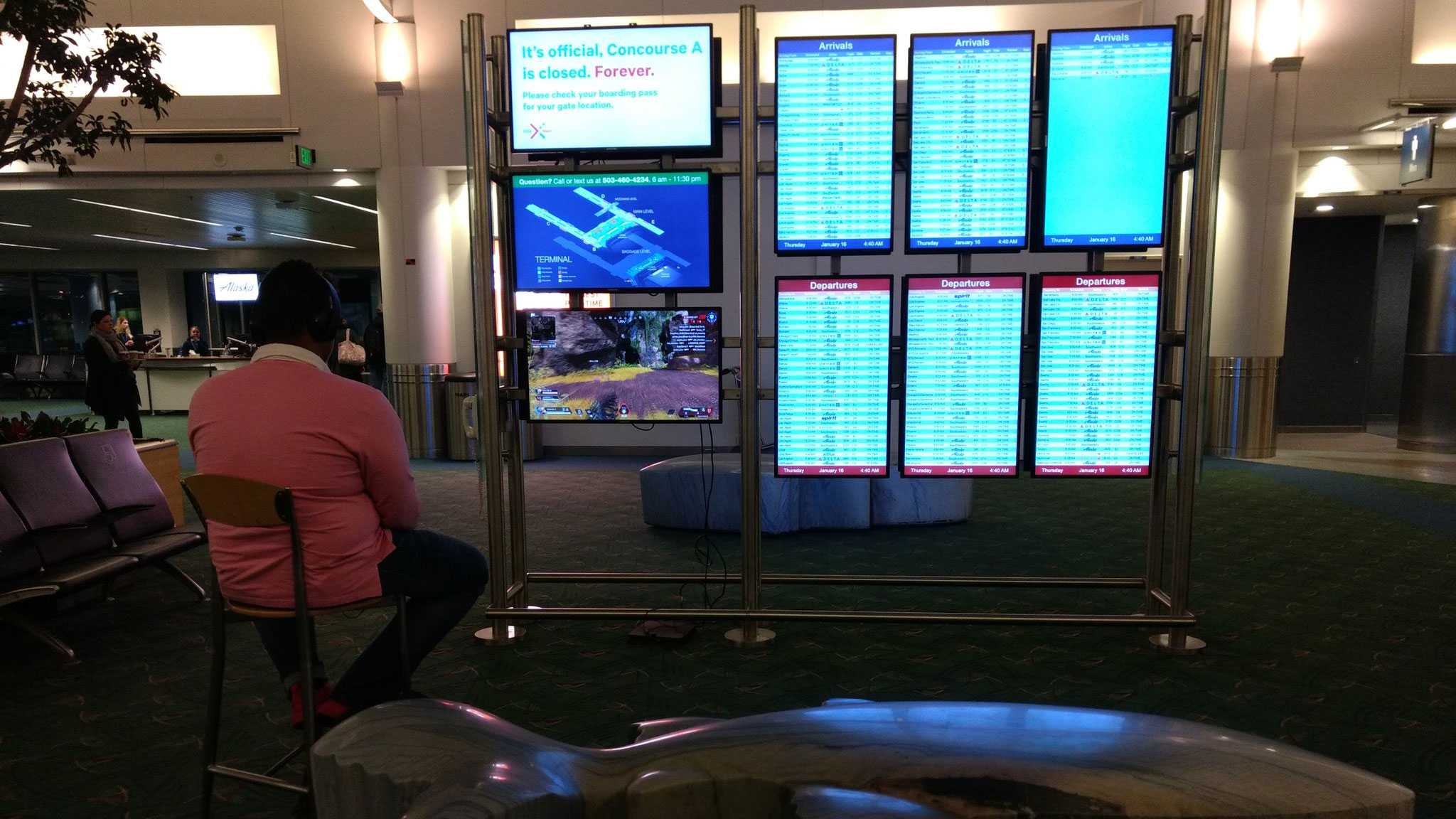 Passenger takes over airport monitor, plays video game while waiting ...