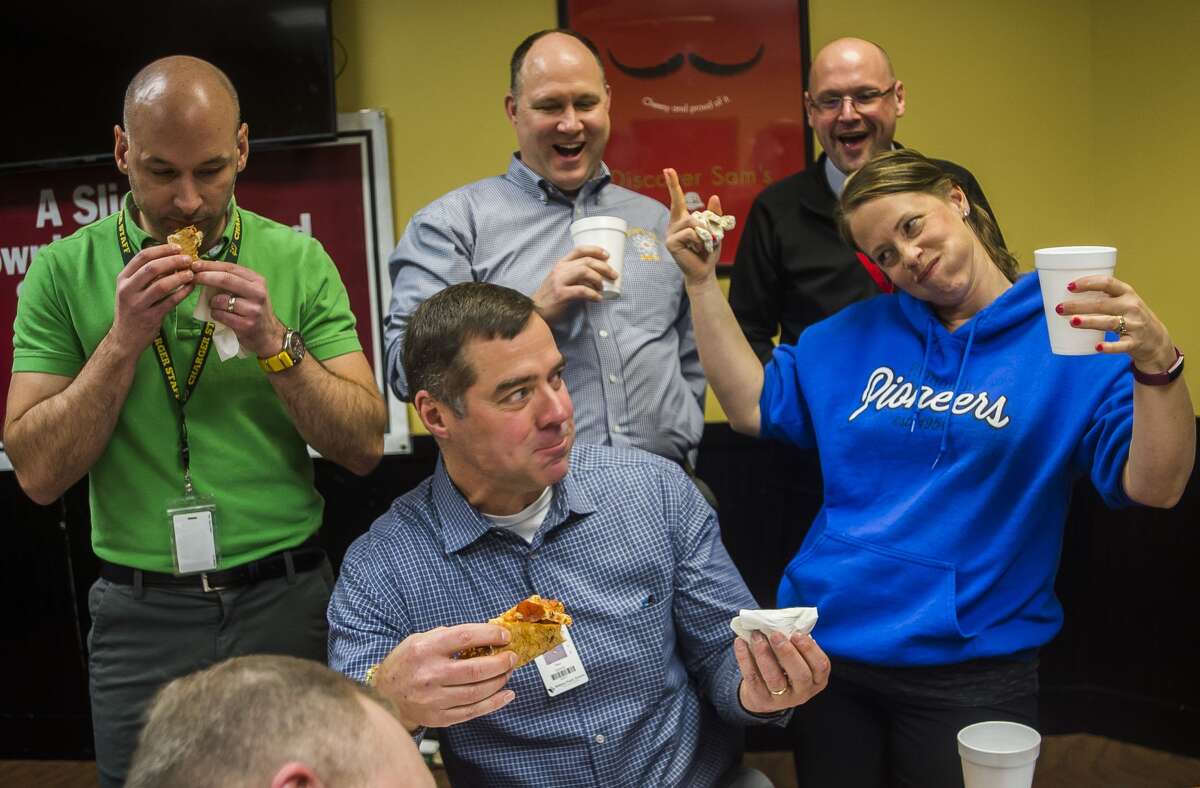 A cheesy challenge: Teams dig in for pizza eating contest