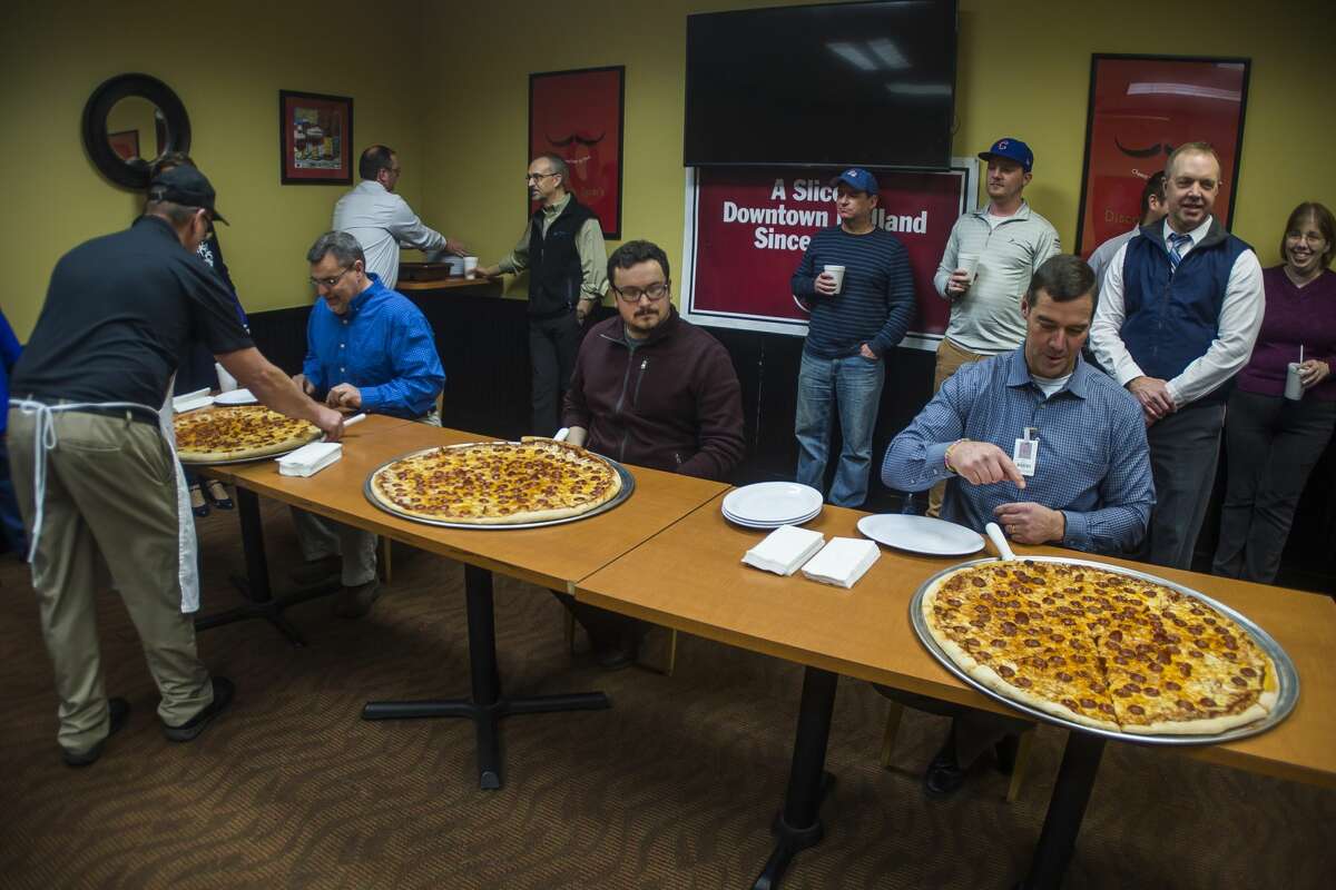 A cheesy challenge: Teams dig in for pizza eating contest