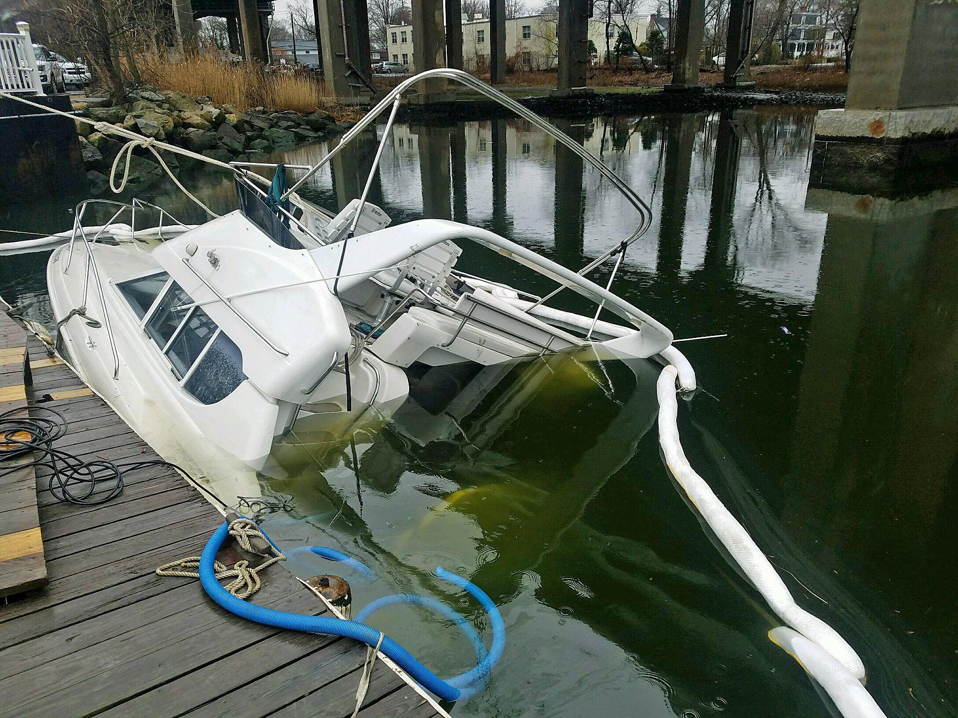 Partially sunken boat leaks oil at Greenwich marina