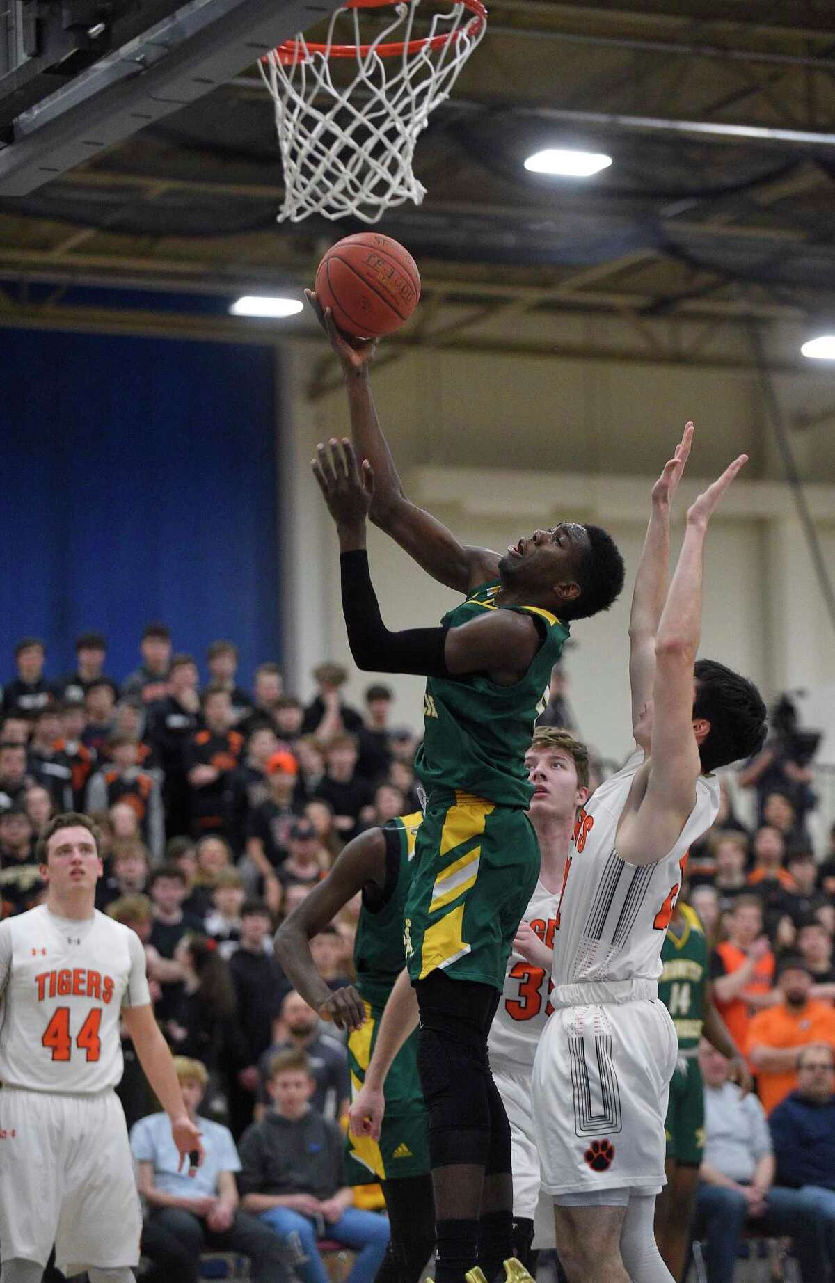 Ridgefield tops Trinity Catholic for third FCIAC boys hoop title in ...
