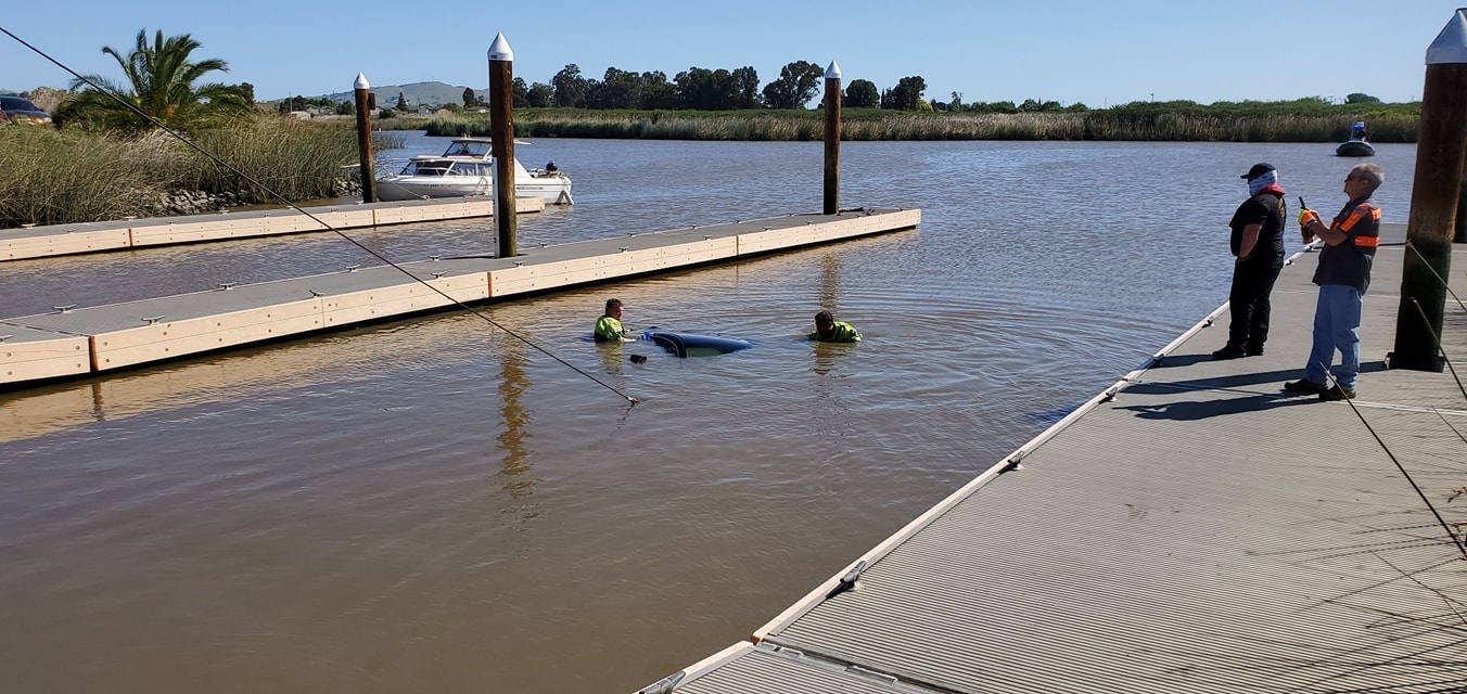 Man dies after driving car off boat launch and into slough