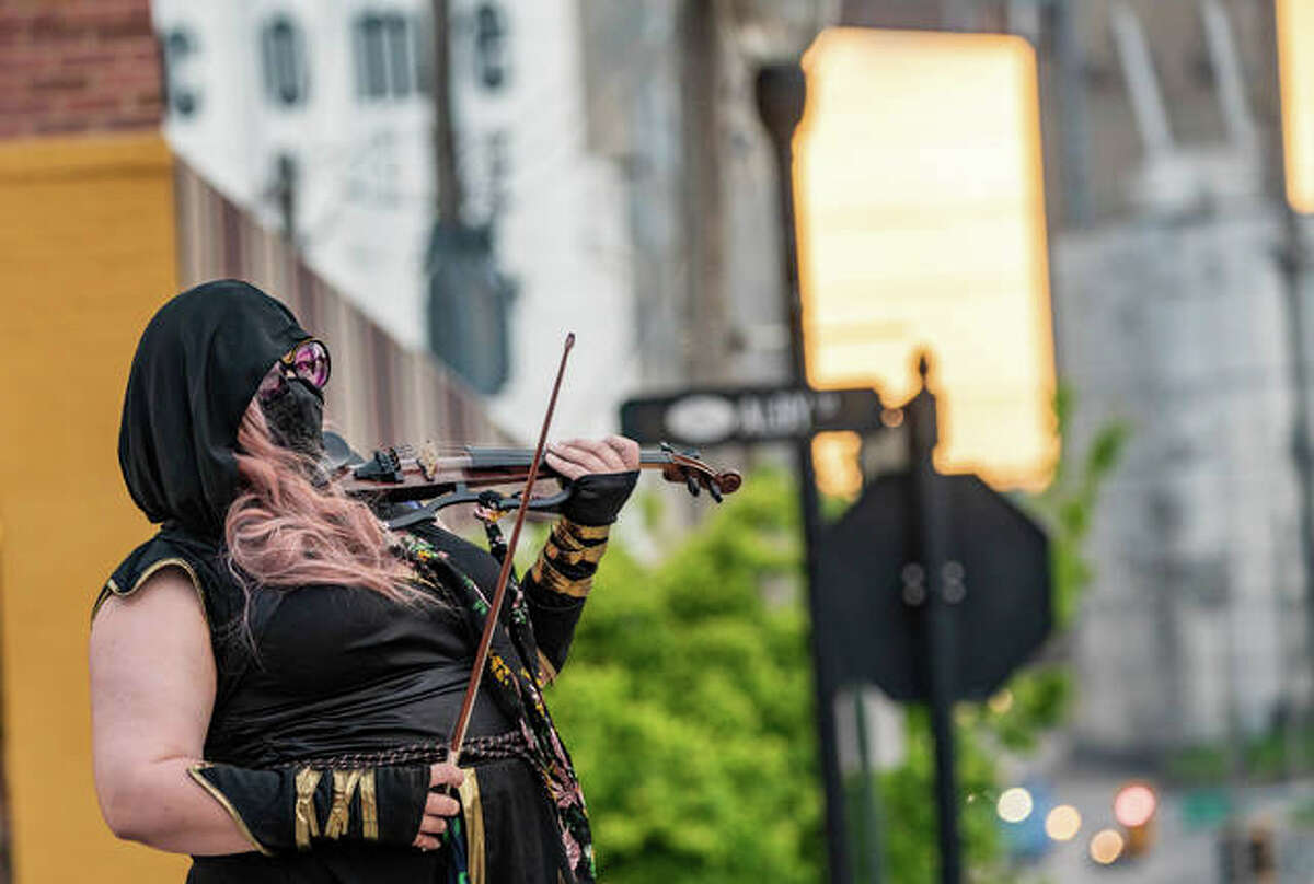 Mysterious, masked fiddler seen walking downtown Alton