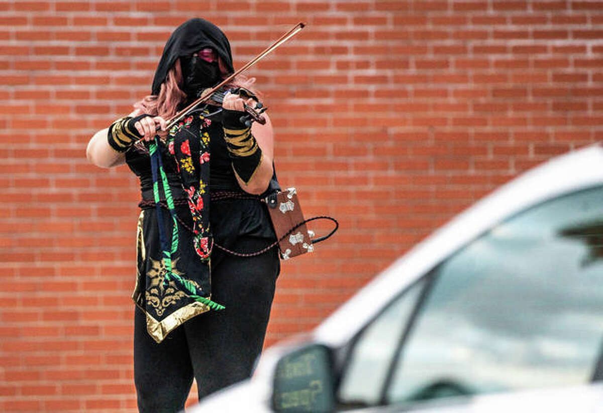 Mysterious, masked fiddler seen walking downtown Alton