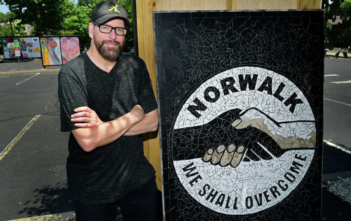 Black, white hands embrace in Norwalk mural urging unity