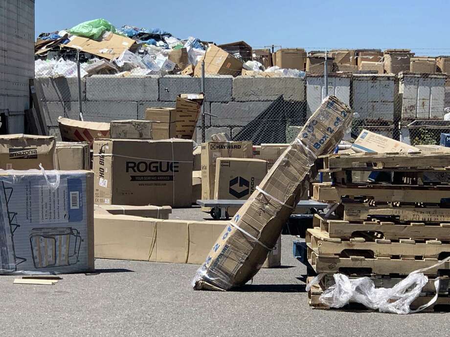 Pile of UPS packages left in parking lot for weeks - Houston Chronicle