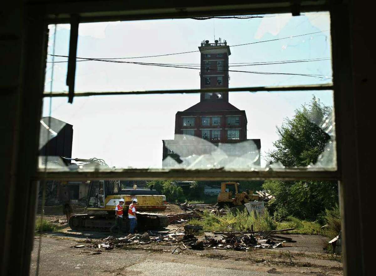 Crews still working to topple burning plant