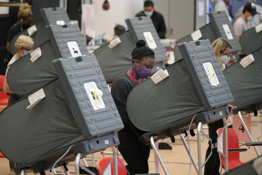 Staff photos on first day of early voting in Texas, Oct. 13, 2020 - Chron