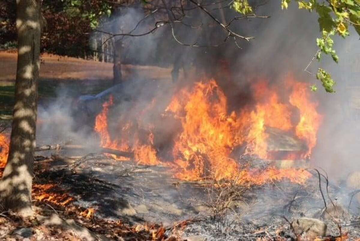 Officials: Unconscious person pulled from burning car at cemetery