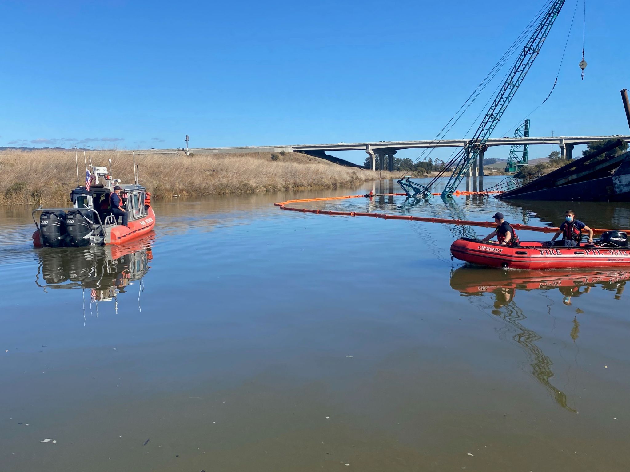 Crews work to limit petroleum spill from sinking barge