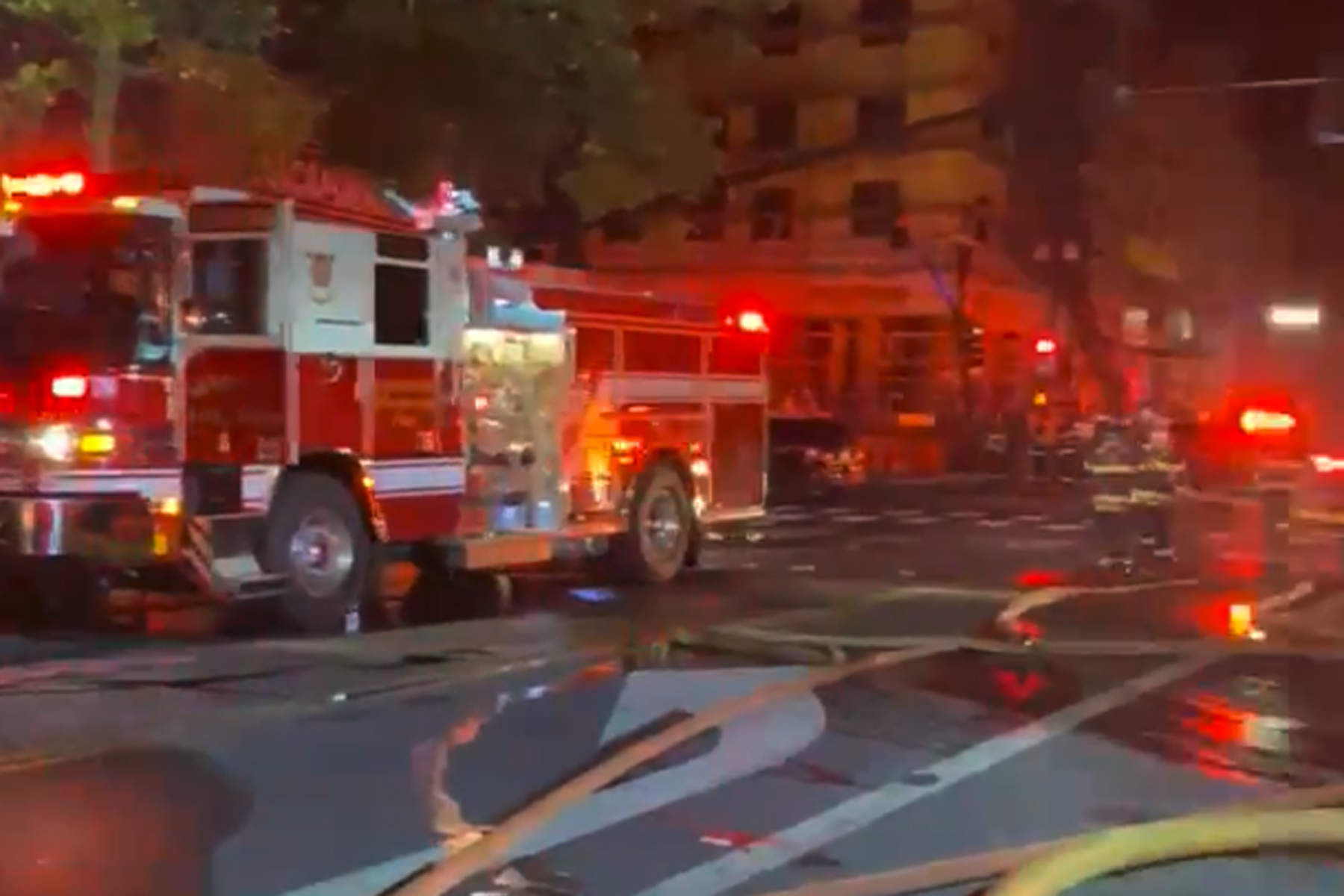 Nearly 100 firefighters battle blaze at apartment building under ...
