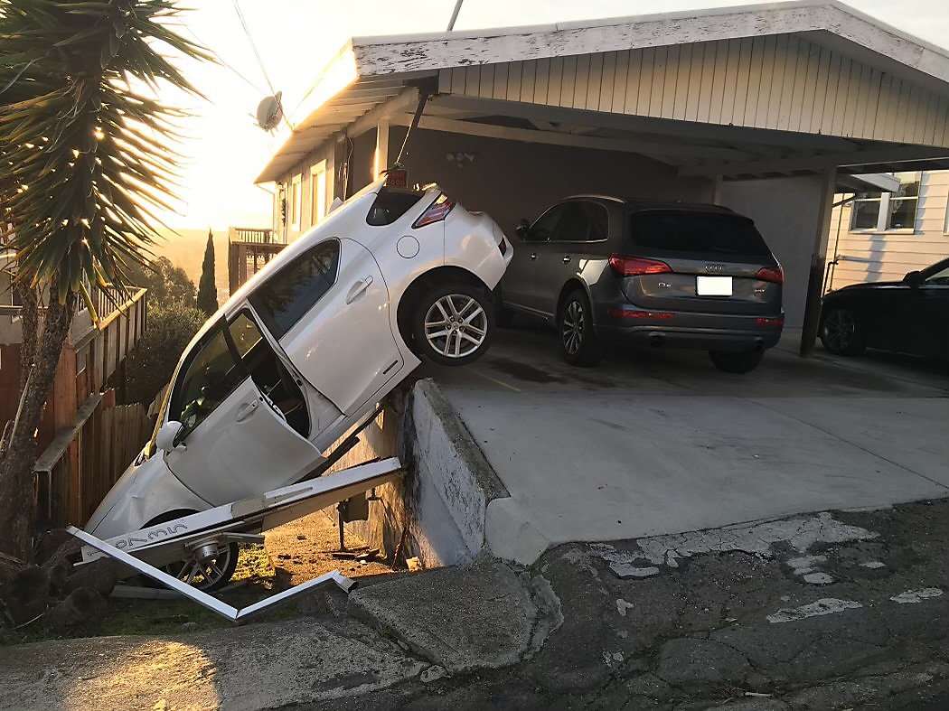 Video: SUV crashes through San Leandro carport, dangles over embankment