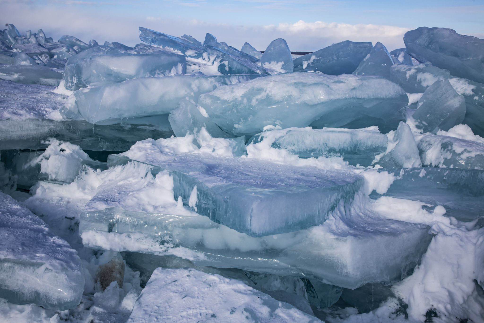 Visitors explore blue ice near Mackinac Bridge - Feb. 22, 2021