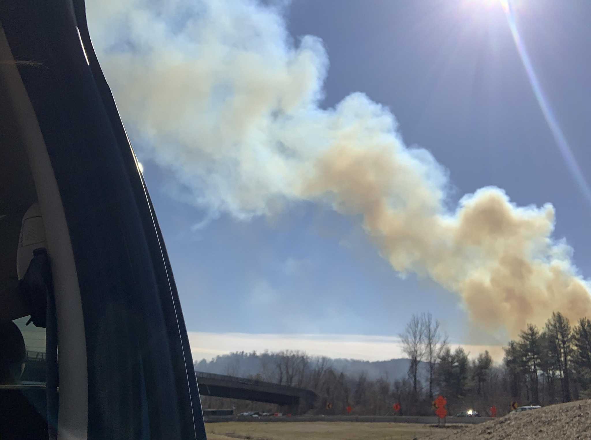 Firefighters battle raging brush fire in Southbury