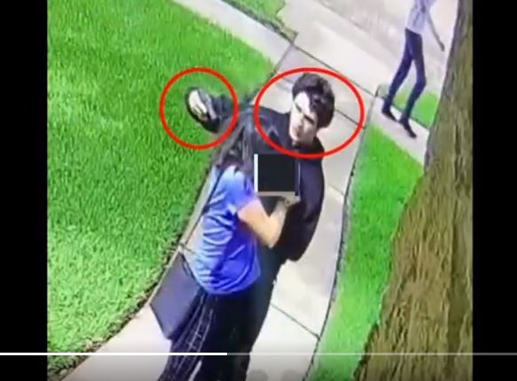 A woman was robbed of her car at gunpoint in her own Houston driveway