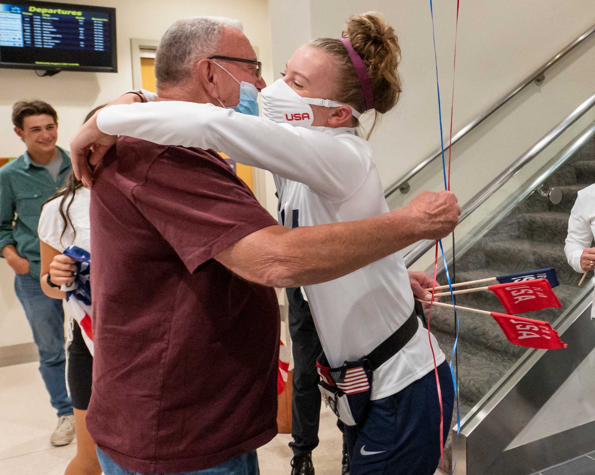 Photos: Olympian Emma White returns home to grand airport reception