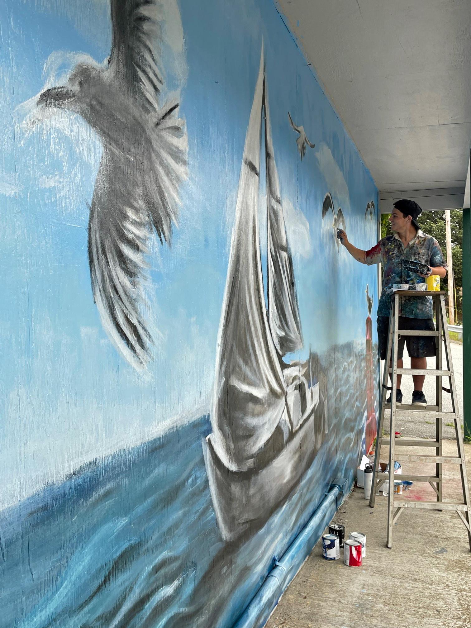 Local artist paints seaside mural on side of Coffee Break