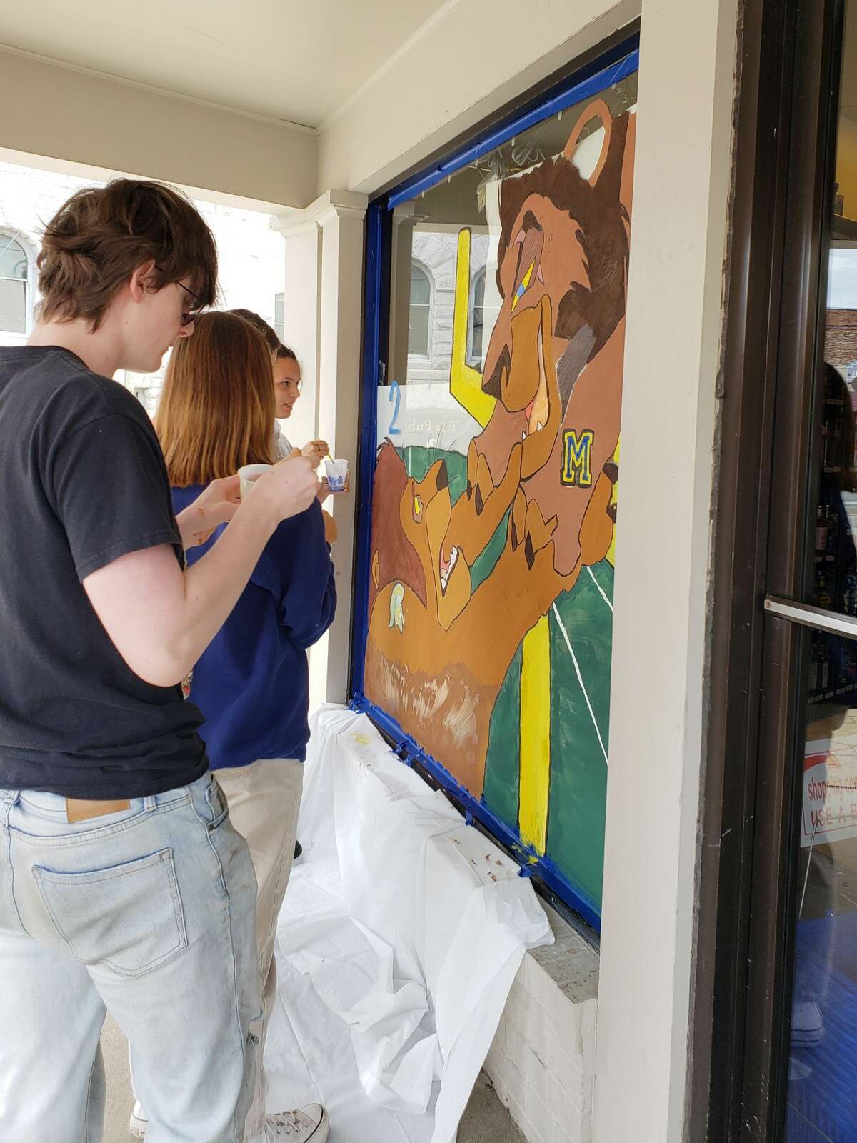 PHOTOS: Look behind the scenes at Manistee's homecoming window art ...