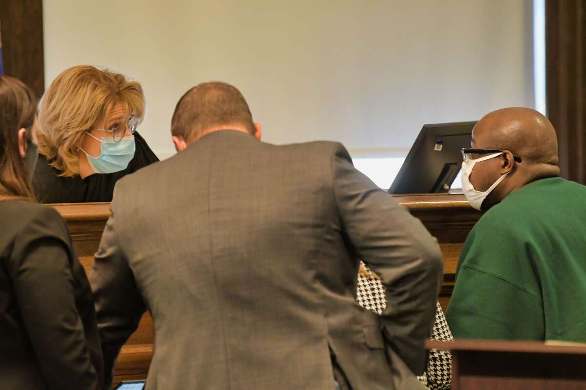 Murder defendant questions medical examiner over victim's skin color