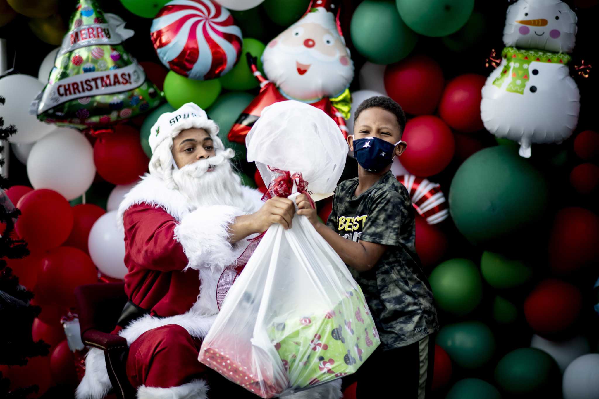 San Antonio Spurs’ Keldon Johnson takes turn as Santa on West Side