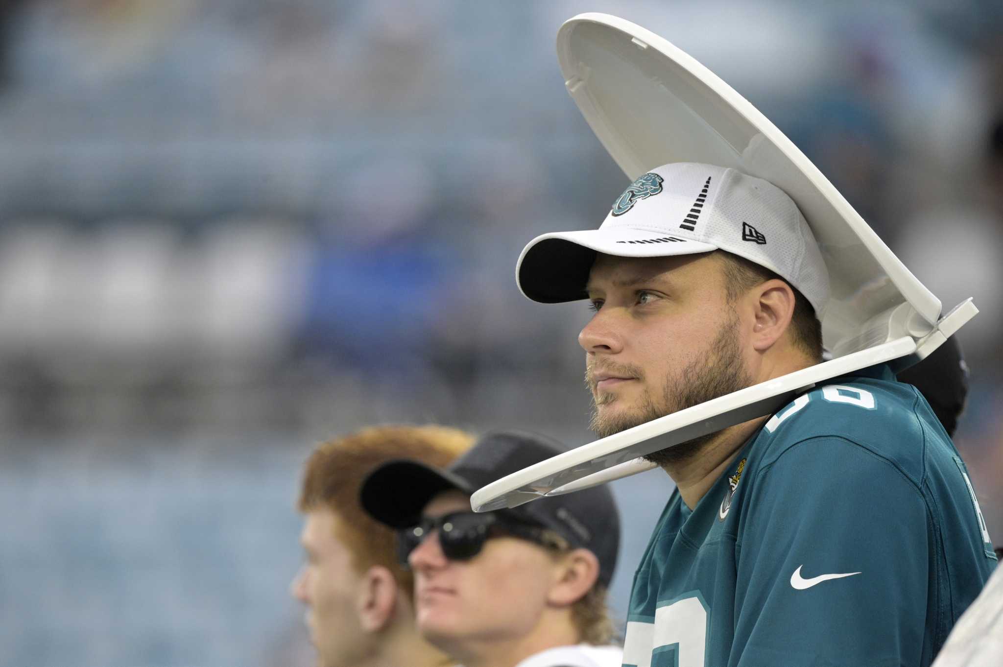 Sad Jaguars fan wears toilet seat over head during Texans' win