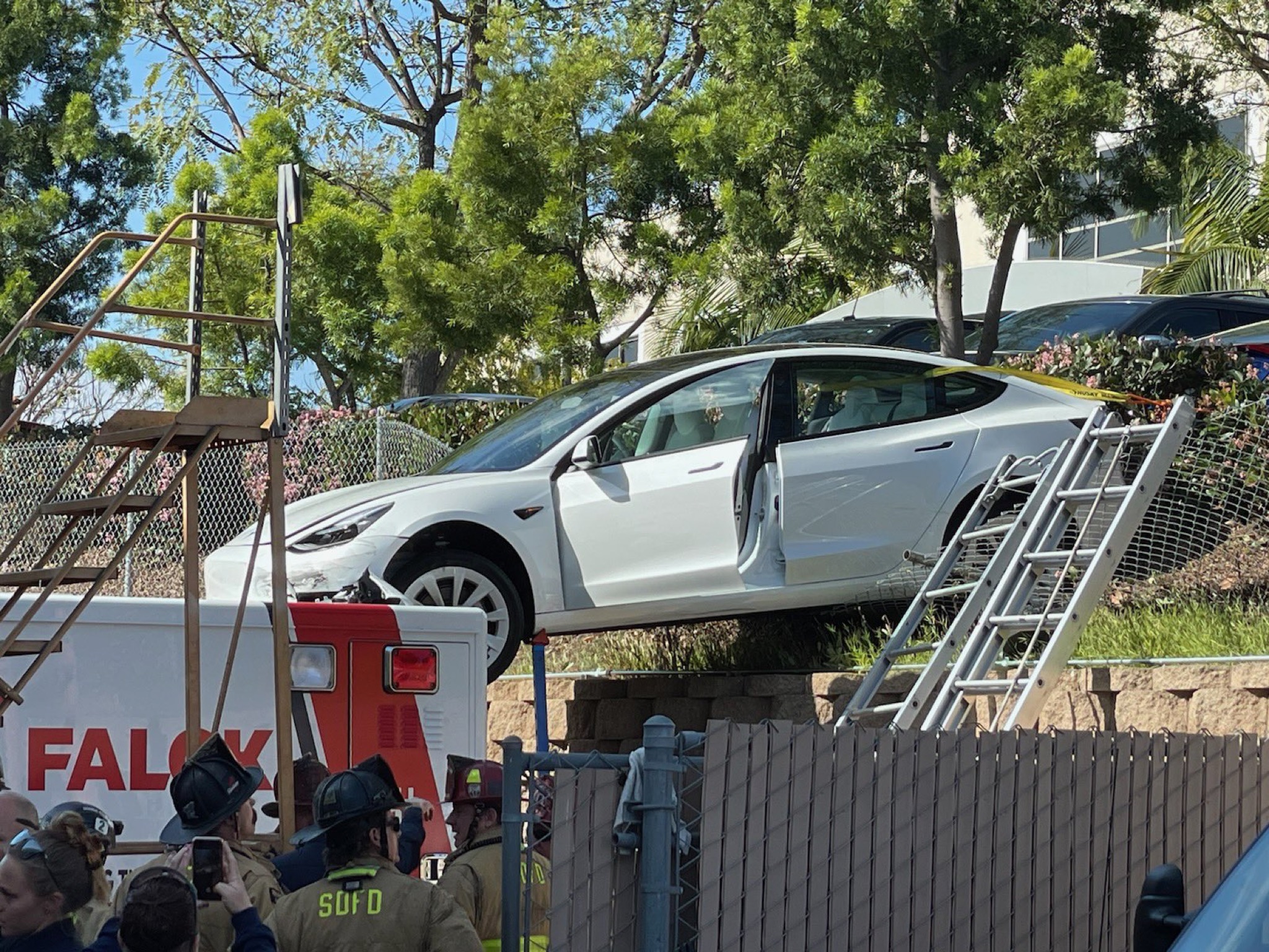 Tesla crashes into roof of ambulance in California, injuring three