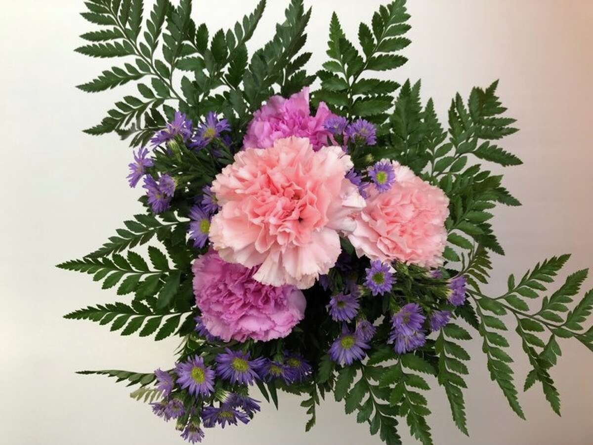 TORI TRIES ... arranging flowers at Smith’s Flowers and Gifts; Longtime ...