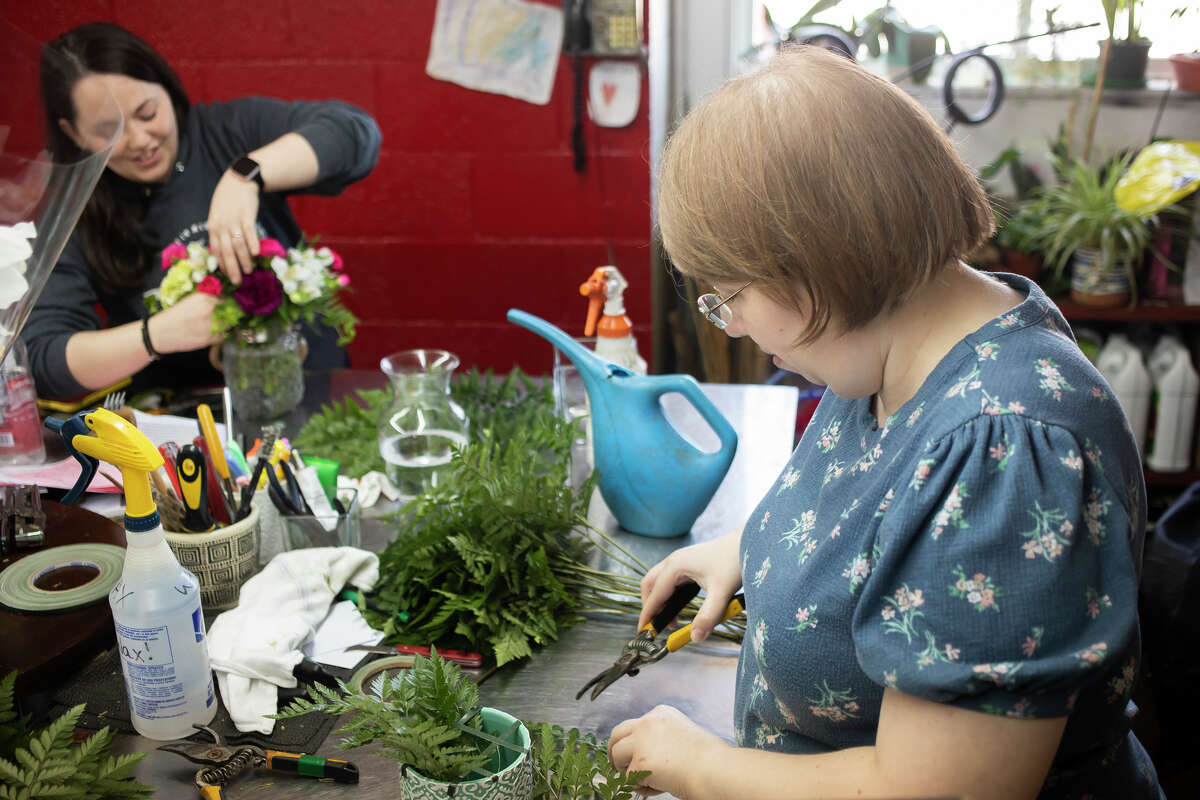 TORI TRIES ... arranging flowers at Smith’s Flowers and Gifts; Longtime ...