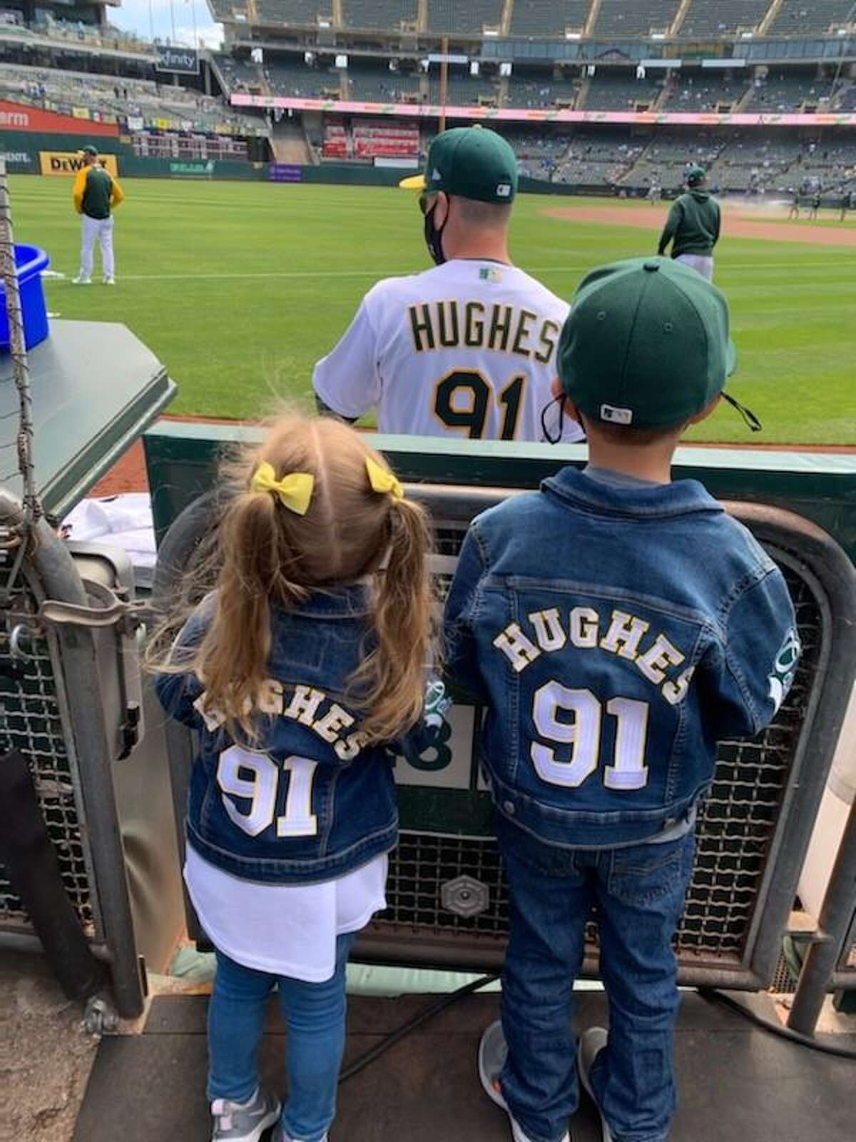 How baseball bonds A’s scout John Hughes and his son, bullpen catcher ...