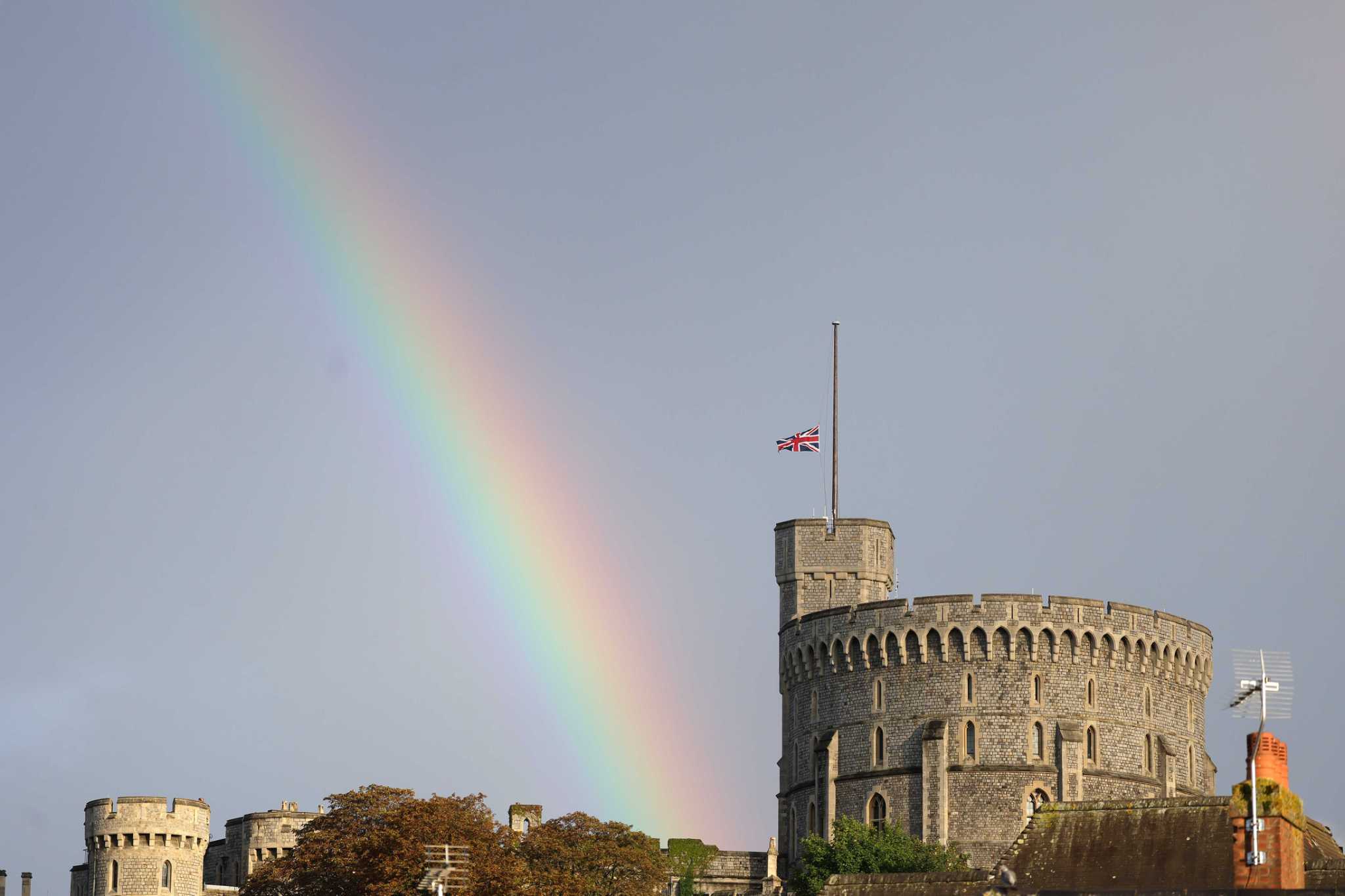 A rainbow covers the sky in Windsor, England as flags lowered in honor ...